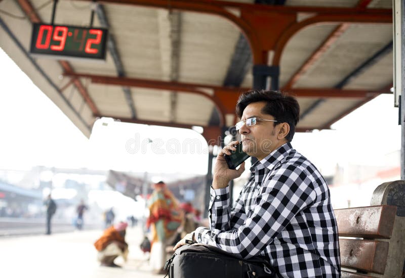 Man Using Phone while Waiting at Railroad Station Platform Stock Image ...