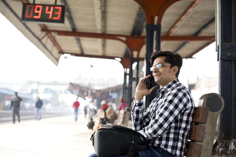 Man Using Phone while Waiting at Railroad Station Platform Stock Photo ...