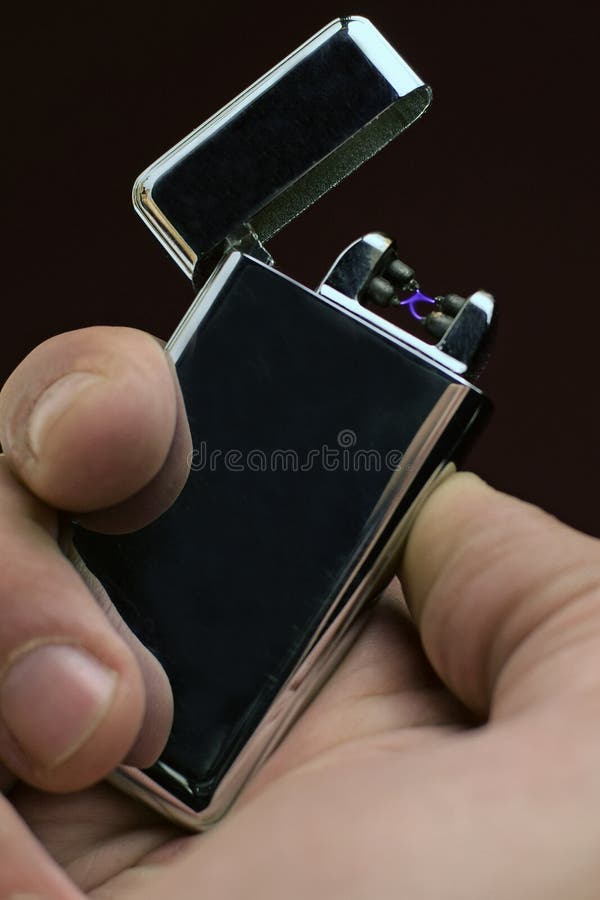 Man Using a Plasma Arc Lighter Stock Image - Image of fire, burn: 128928231