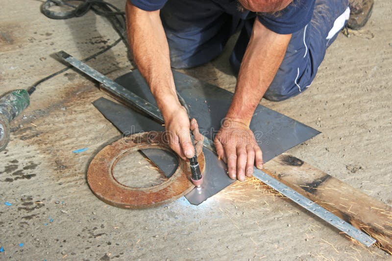 Man using a plasma cutter stock image. Image of builder - 175395301