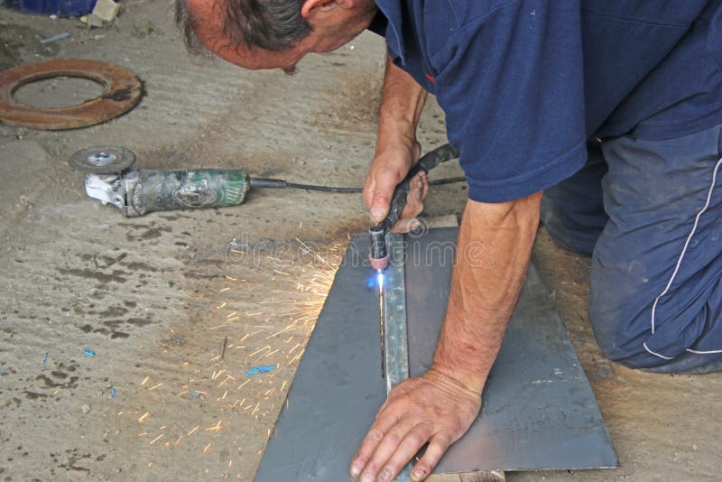 Man using a plasma cutter stock photo. Image of cutting - 174086966