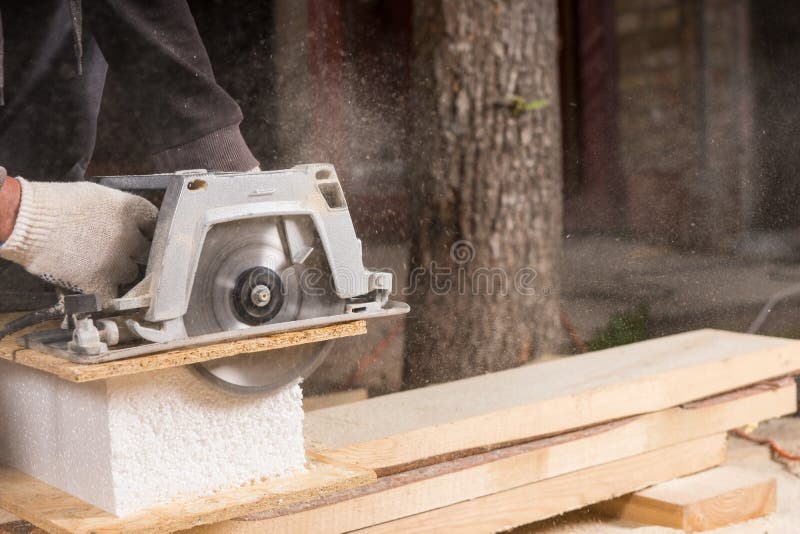 Man Using Power Saw To Cut Planks of Wood Stock Photo - Image of feet ...