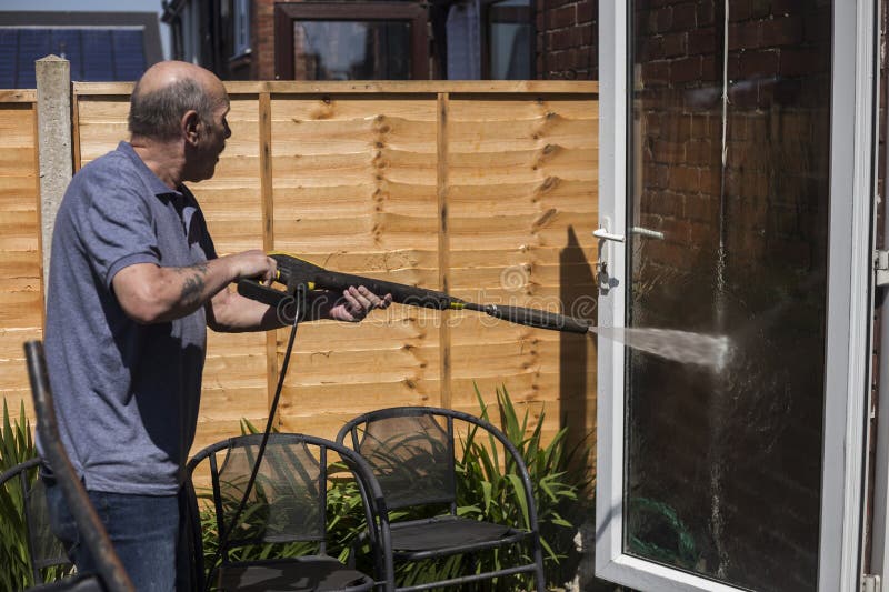 Man Using a Pressure Washer Stock Image - Image of pergola, tree: 349389529