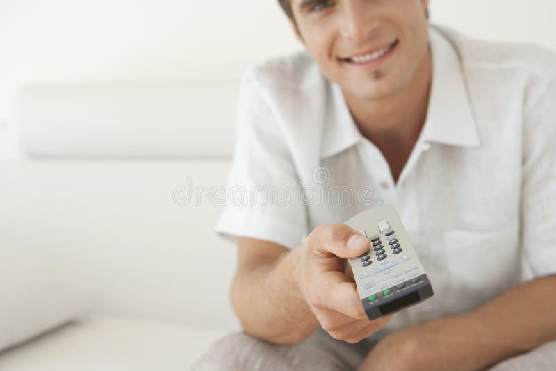 Man Using a Remote Control stock photo. Image of design - 24787316