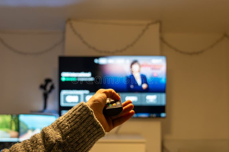 Man Using Remote Control, Changing Channels on Television, Watching ...