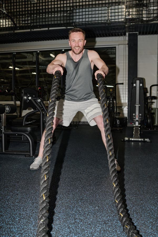 Man Using Ropes in Gym stock image. Image of effort - 332517329