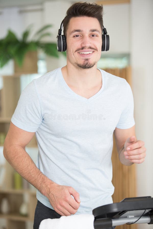 Man Using Running Exercise Machine at Home Stock Photo - Image of ...