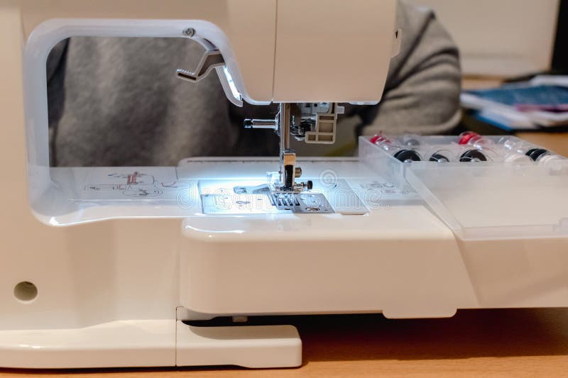 Man Using a Sewing Machine with a Garment, for Repair Work ...