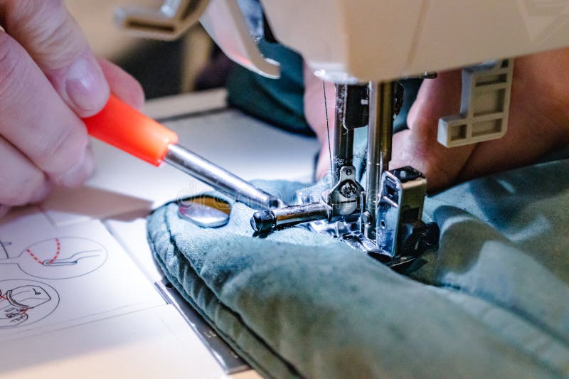Man Using a Sewing Machine with a Garment, for Repair Work ...