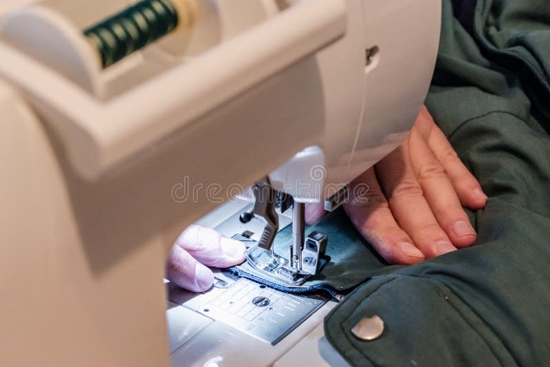 Man Using a Sewing Machine with a Garment, for Repair Work ...