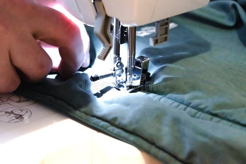 Man Using a Sewing Machine with a Garment, for Repair Work ...