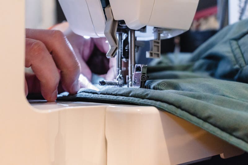 Man Using a Sewing Machine with a Garment, for Repair Work ...