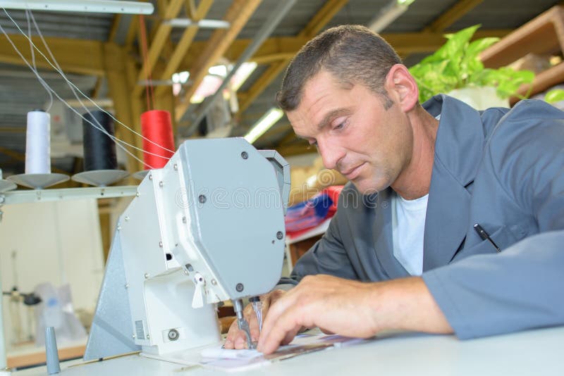 Man using sewing machine stock image. Image of couture - 124178961
