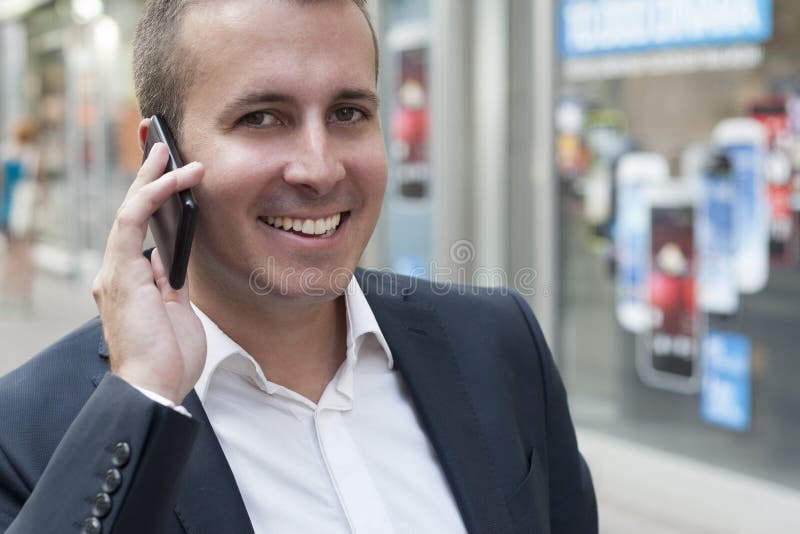 Good Looking Man with Smart Phone Seeting on Floor Stock Image - Image ...