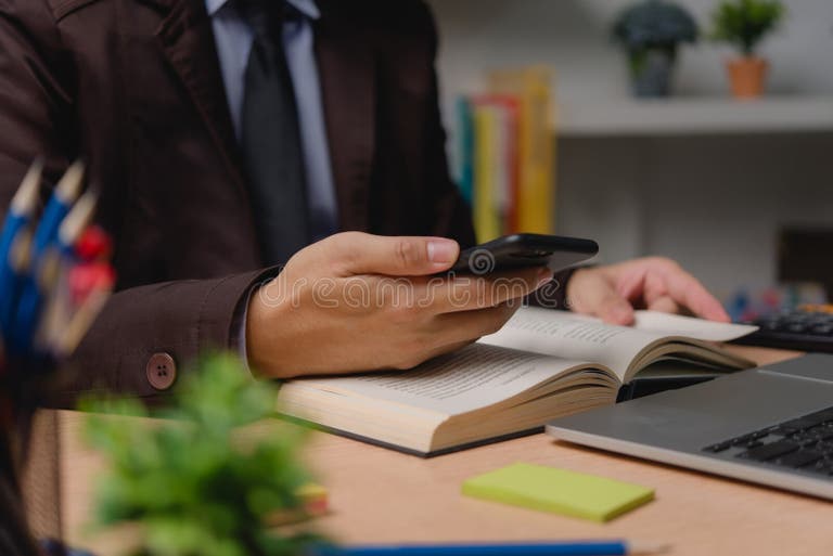 Man Using Smartphone Digital Devices Reading a Book Workstation Digital ...