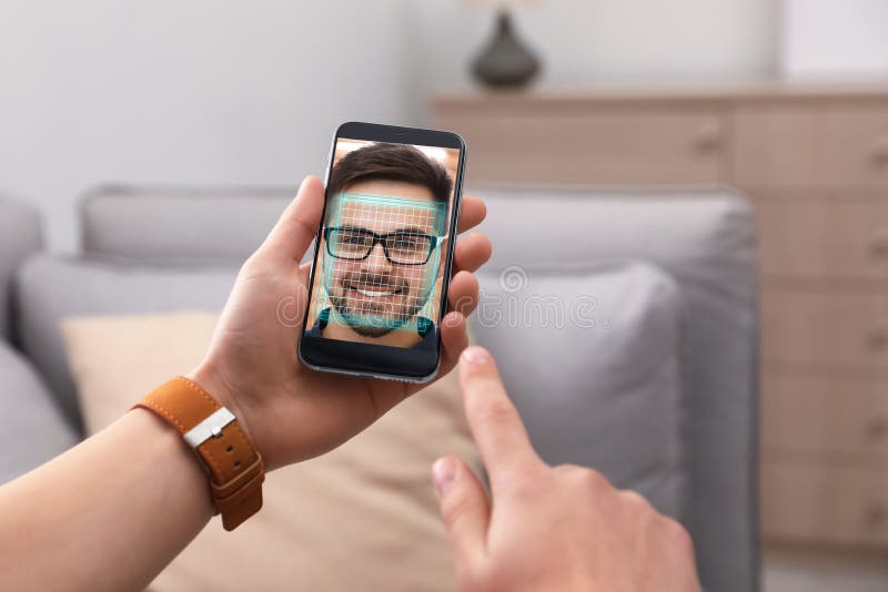Man Using Smartphone With Facial Recognition System Indoors Biometric