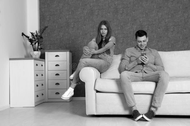 Man Using Smartphone and Ignoring His Girlfriend in Room. Loneliness ...