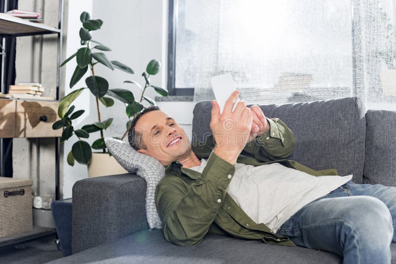 Man Using Smartphone while Laying Stock Photo - Image of electronics ...