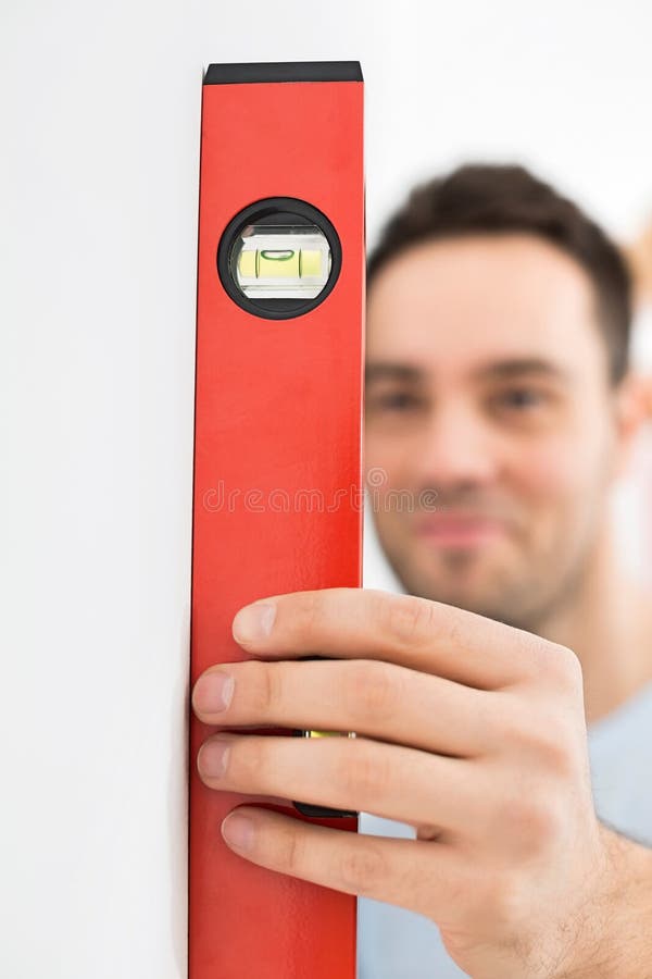 Man Using Spirit Level in New House Stock Photo - Image of people, home ...