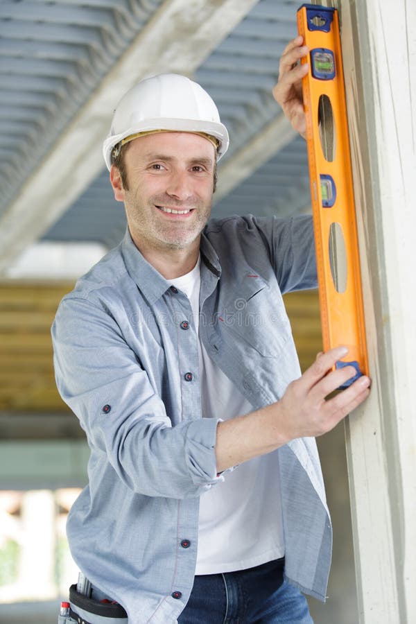 Man Using Spirit Level To Plumb Wall Stock Photo - Image of spirit ...