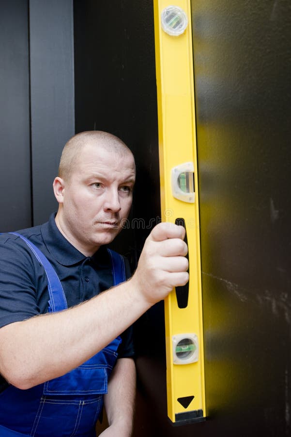 Man using a spirit level stock photo. Image of male, level - 34424678