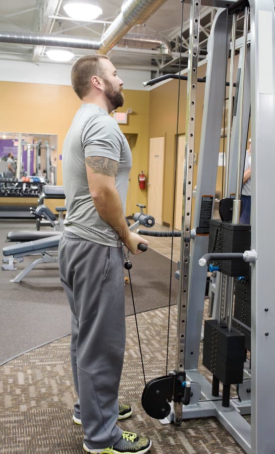 Man Using Straight Bar Cable Pull Stock Image - Image of exercising ...