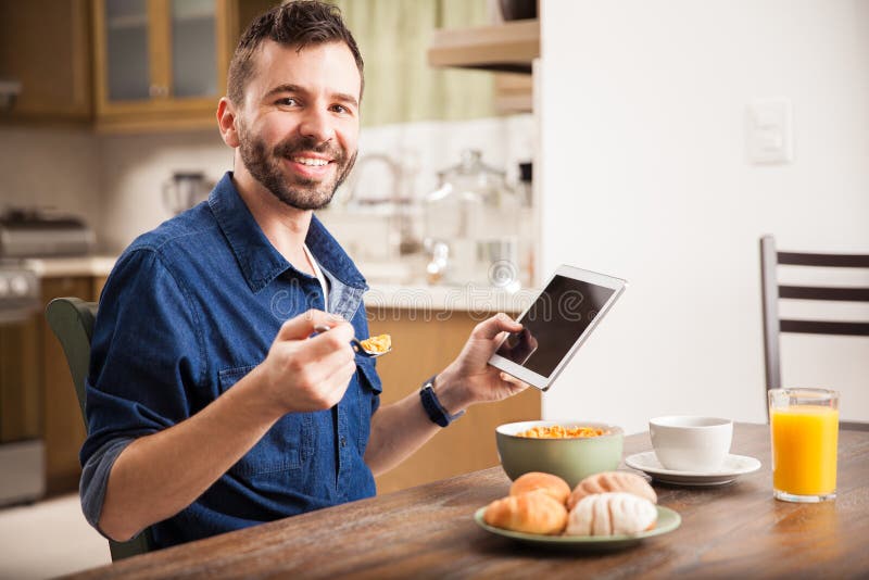 Man Using a Tablet Over Breakfast Stock Image - Image of bowl, hispanic ...