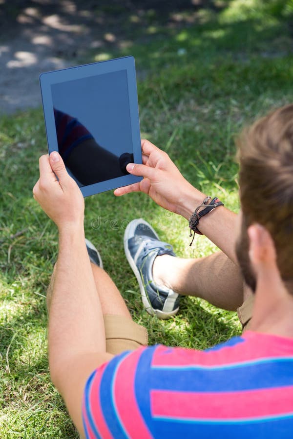 Man Using Tablet in the Park Stock Photo - Image of nature, hipster ...