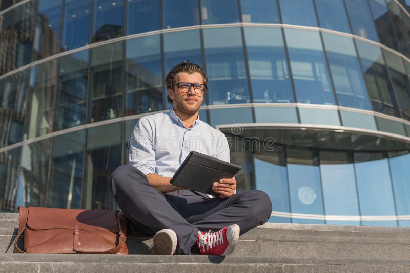 Man Using Tablet Pc Sitting on Stairs Near Modern Glass Building Stock ...