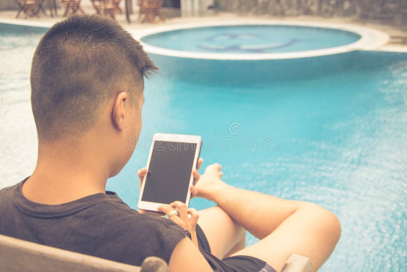 Man Using Tablet on Swimming Pool Background Stock Image - Image of ...