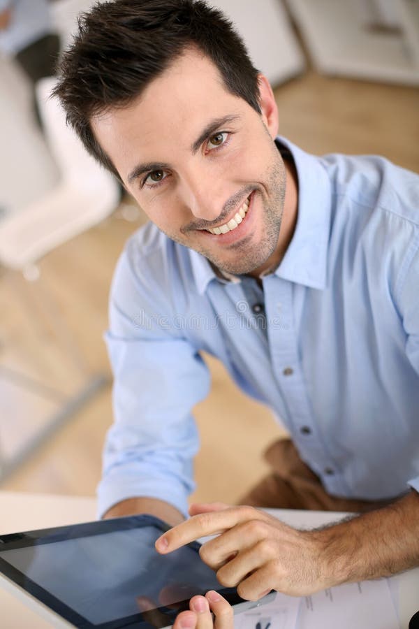Man using tablet at work stock image. Image of smiling - 31545869