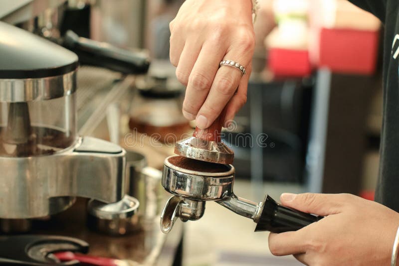 Man Using a Temper To Press Freshly Ground Coffee into a Tablet Stock ...