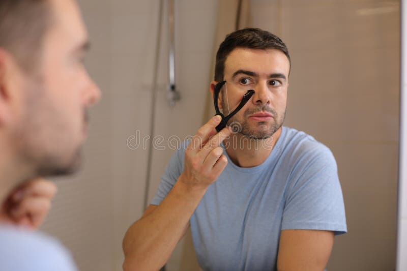 Man Using Threading As a Method for Hair Removal Stock Photo - Image of ...