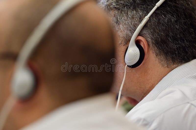 Man Using Translation Headphones Stock Photo - Image of head, event ...