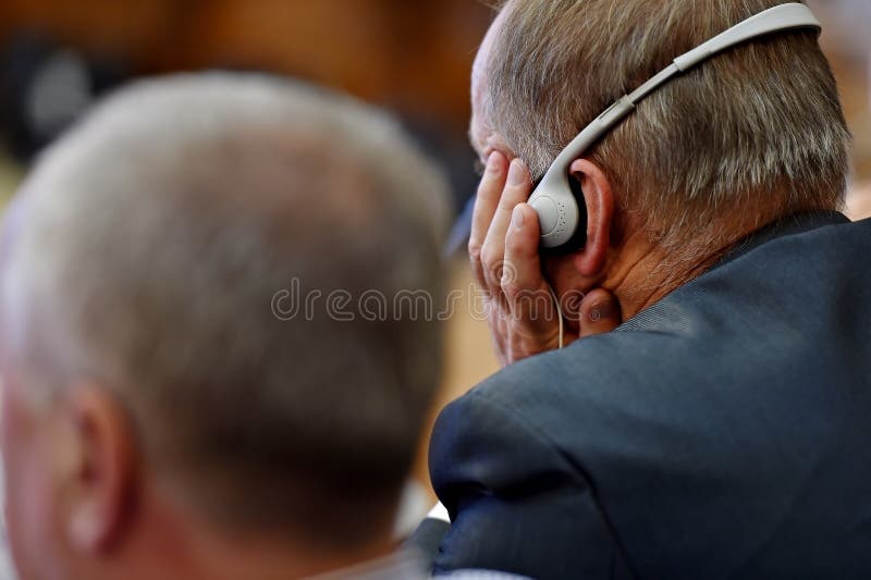 Man Using Translation Headphones Stock Photo - Image of head, event ...