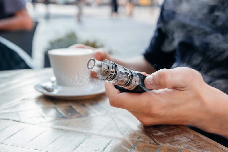 Man Using Vape or Electronic Cigarette and Drinking Coffee Stock Image ...
