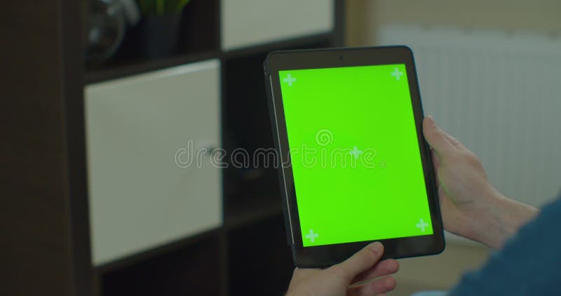 Man Using Vertical TabletPC with Green Screen. Close-up Shot of Man`s ...