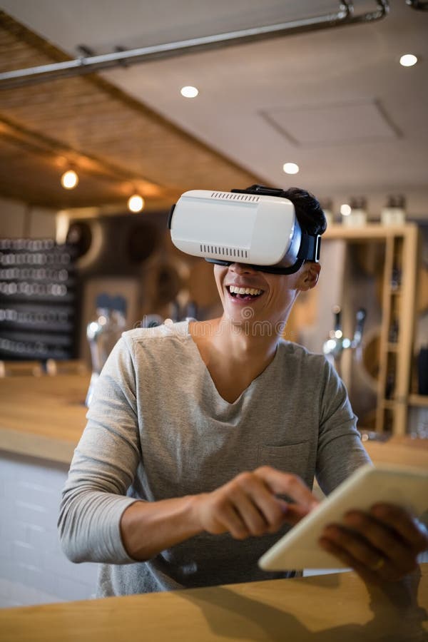Man Using Virtual Reality Headset and Digital Tablet in Restaurant ...