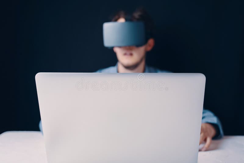 Man Using Virtual Reality Headset and Laptop for Immersive Technology ...