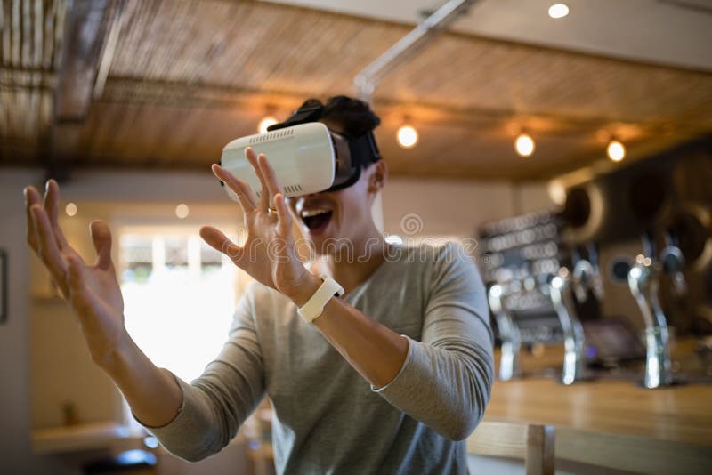 Man Using Virtual Reality Headset and Digital Tablet in Restaurant ...