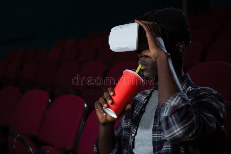 Man Using Virtual Reality Headset while Watching Movie Stock Photo ... Man Using Virtual Reality Headset while Watching Movie Stock Photo ...