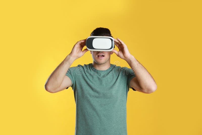Man Using Virtual Reality Headset on Yellow Background Stock Image ...