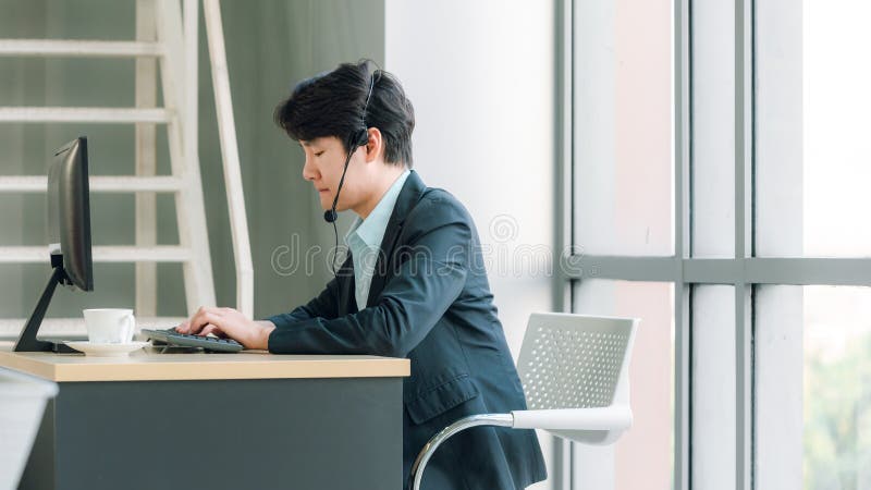 Man Using VOIP Headset with Digital Tablet Computer Docking Smart ...