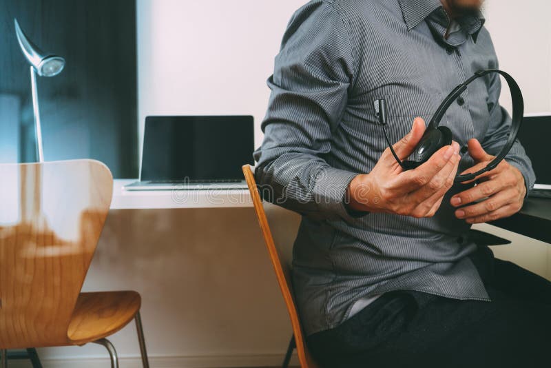 Man Using VOIP Headset with Digital Tablet and Laptop Computer a Stock ...