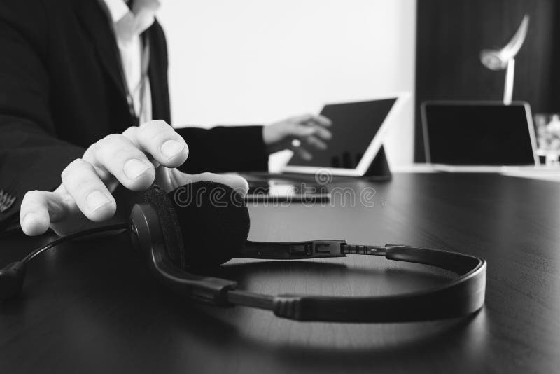 Man Using VOIP Headset with Digital Tablet and Laptop Computer a Stock ...