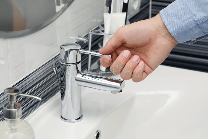Man Using Water Tap in Bathroom, Closeup Stock Photo - Image of ...