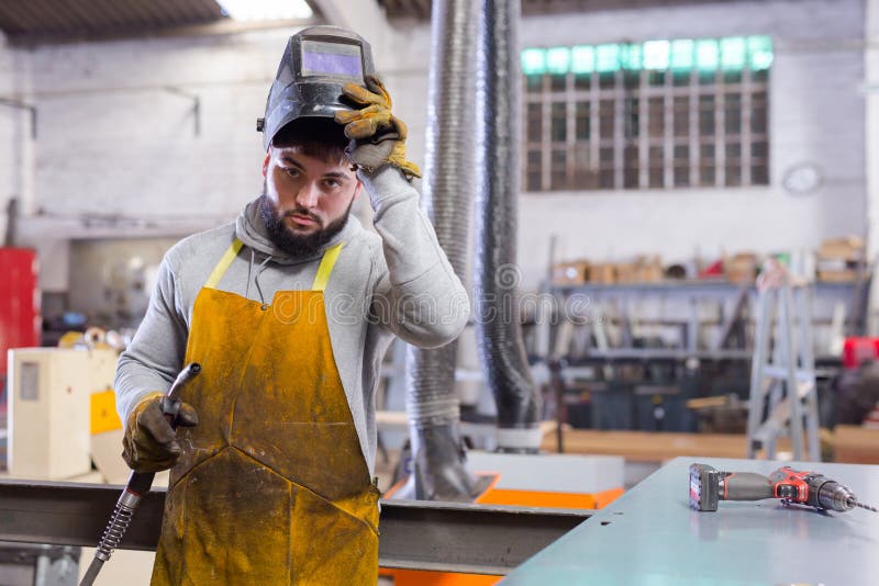 Man Using Welder for Construction Work at the Workshop Stock Photo ...