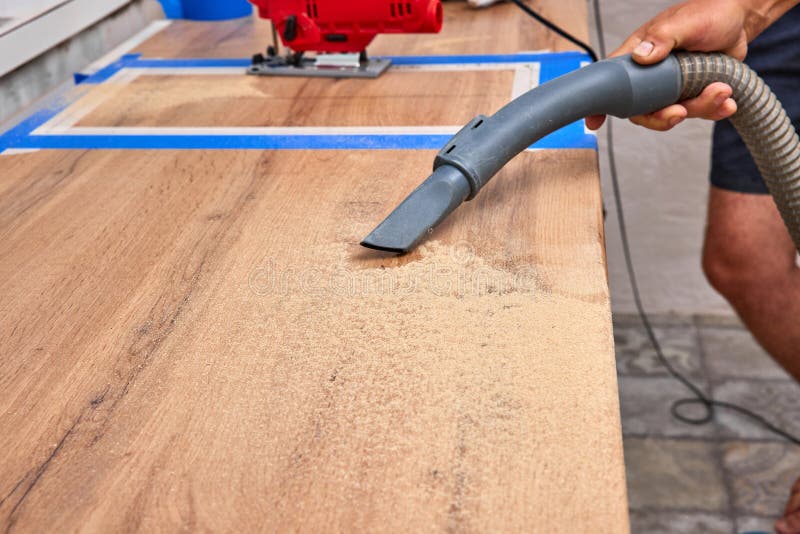 Man Vacuums New Kitchen after Cutting Hole for the Sink in the Kitchen ...