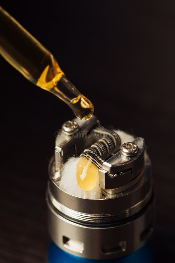 Man in a Vape Shop is Filling a Special Liquid in E-cigarette. Stock ...