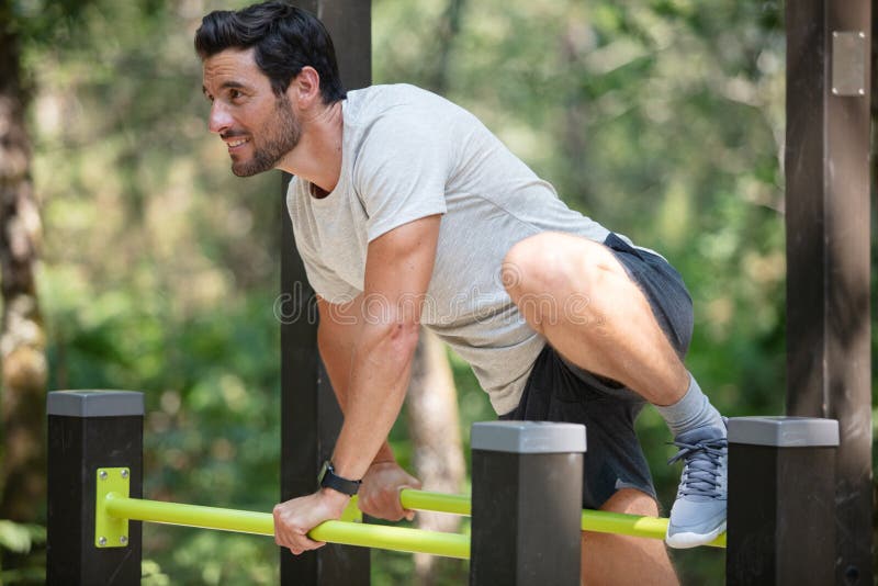 Man Vaulting Over Bars in Park Stock Image - Image of male, athletic ...